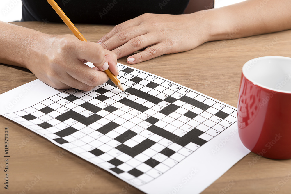 Solving crossword puzzle with yellow pencil close up. Stock Photo ...