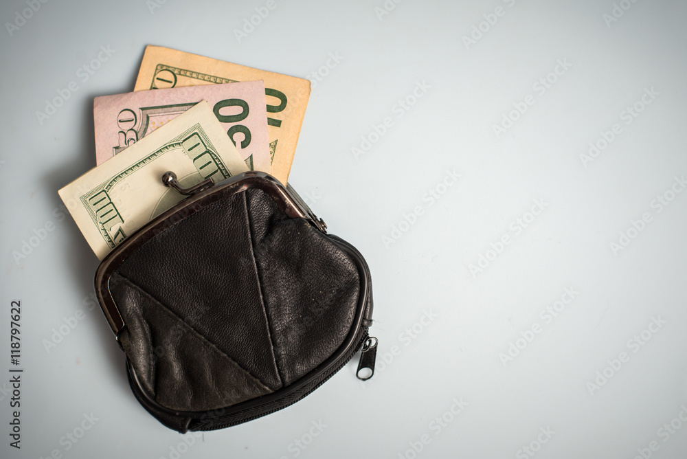 Old vintage leather wallet with money isolated on white background ...