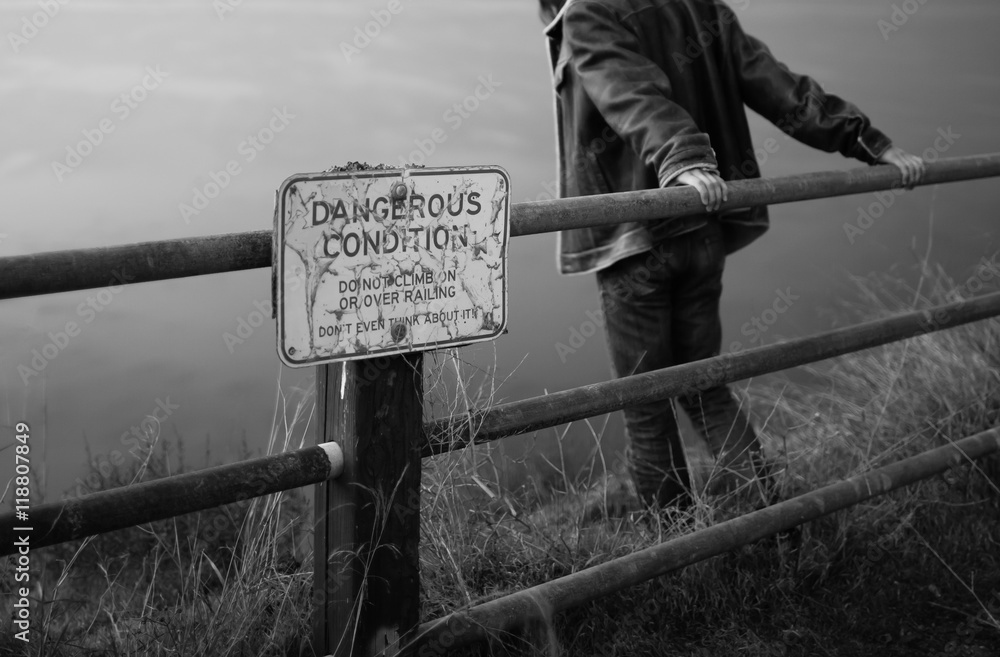 Depressed man standing on edge of cliff. Stock Photo | Adobe Stock