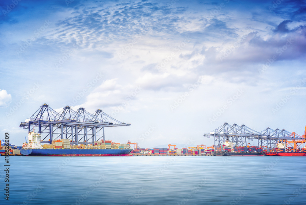 Container Cargo ship with working crane bridge in seaport for logistic ...