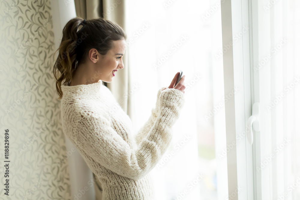 Woman by the window Stock Photo | Adobe Stock