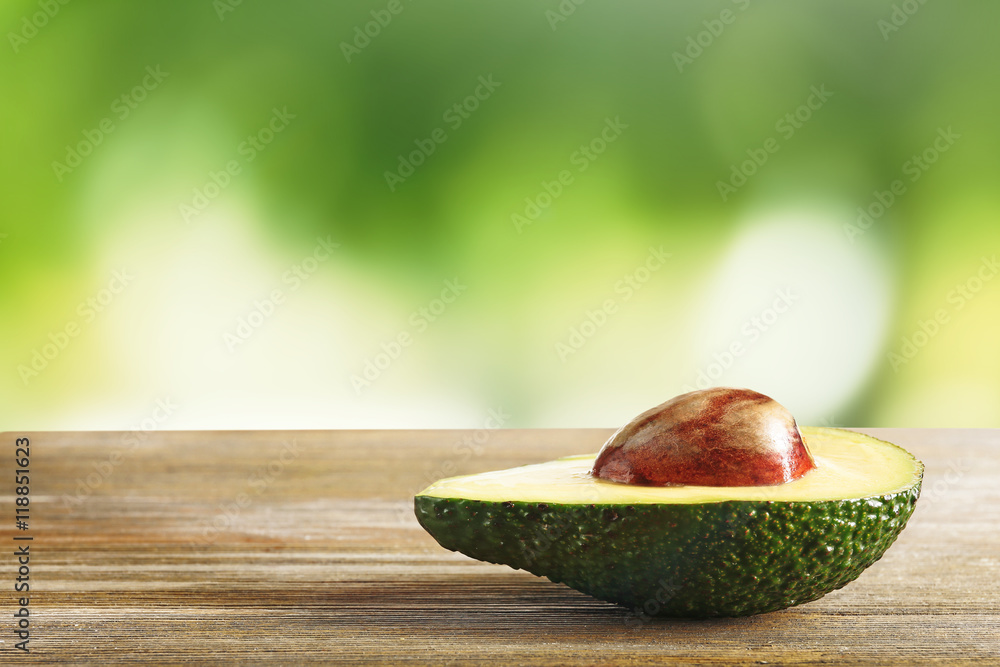 Fresh avocado on the table, on blurred nature background Stock-Foto ...