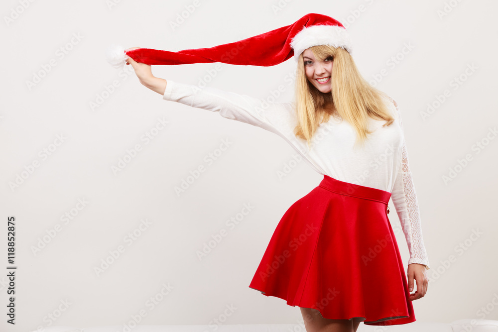 Happy cute woman in santa helper hat. Christmas. Stock Photo | Adobe Stock