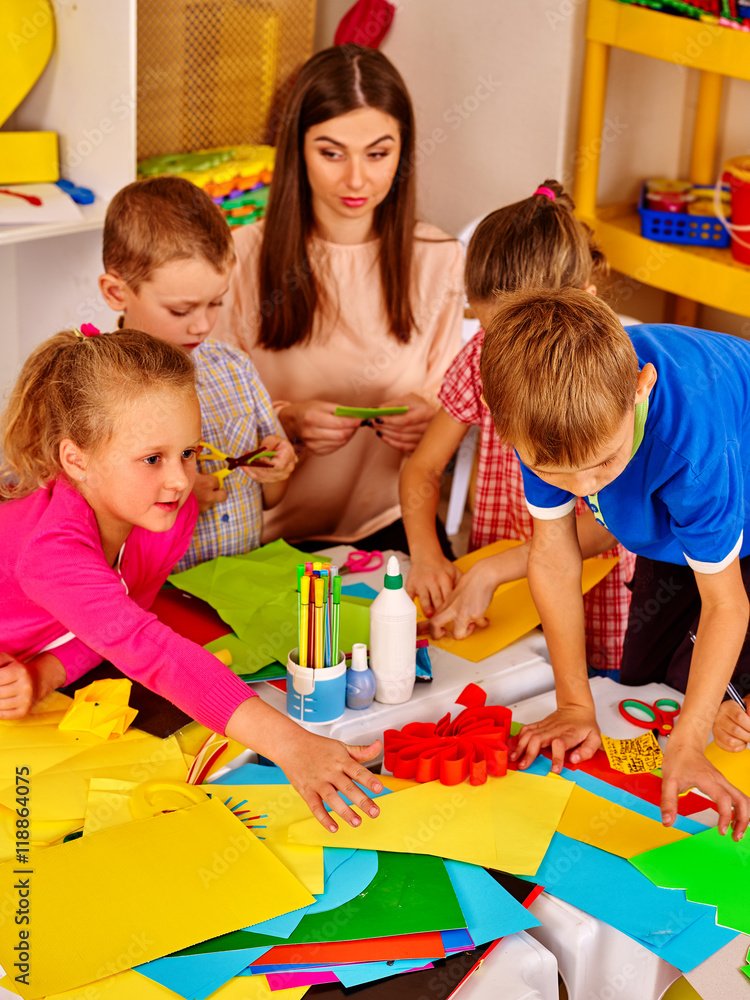 Large group of children with teacher friendly making something out of ...
