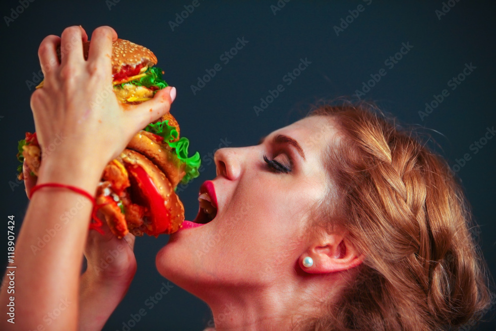Girl with mouth wide open hamburger eating hamburger. Hamburger is ...