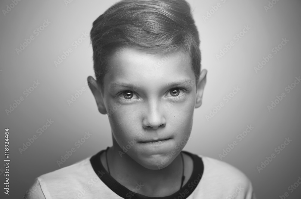 Serious handsome teenage blond boy with stylish haircut and bright ...