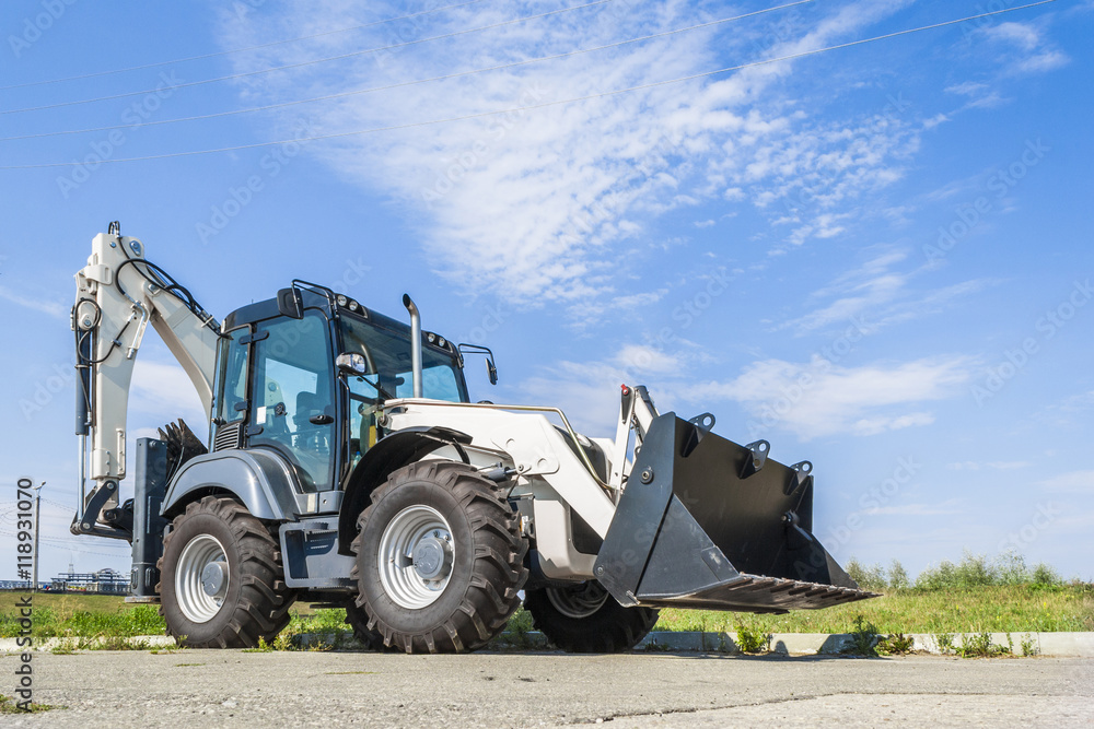 The new tractor is on the road in the city Stock Photo | Adobe Stock