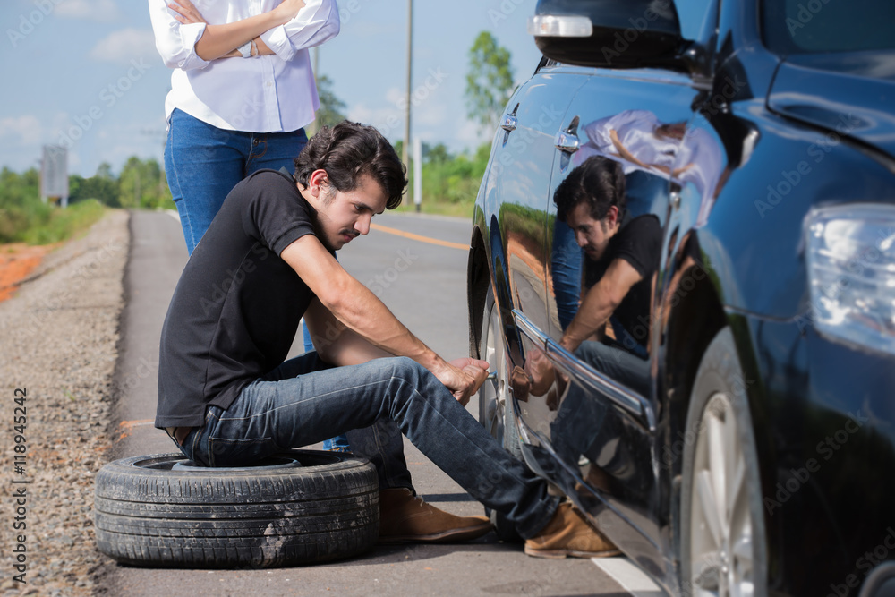 Man changing tire That are leaking His car broke down en route t Stock ...
