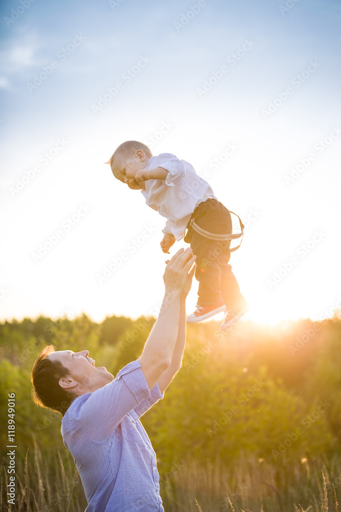 Happy father with his adorable toddler boy son on sunset. Father ...