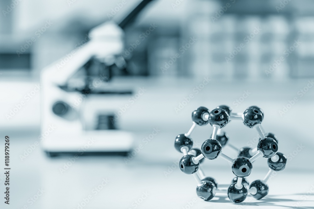 Microscope and model of molecule in laboratory Stock Photo | Adobe Stock