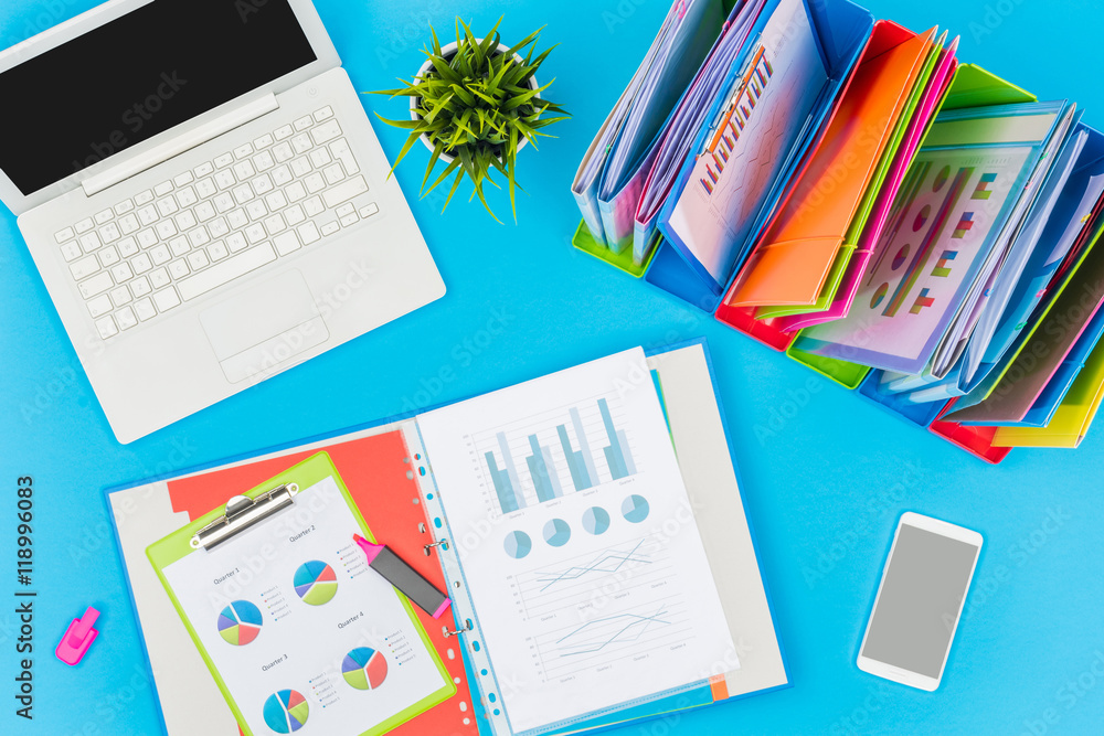 Blue office table with laptop and documents Stock Photo | Adobe Stock