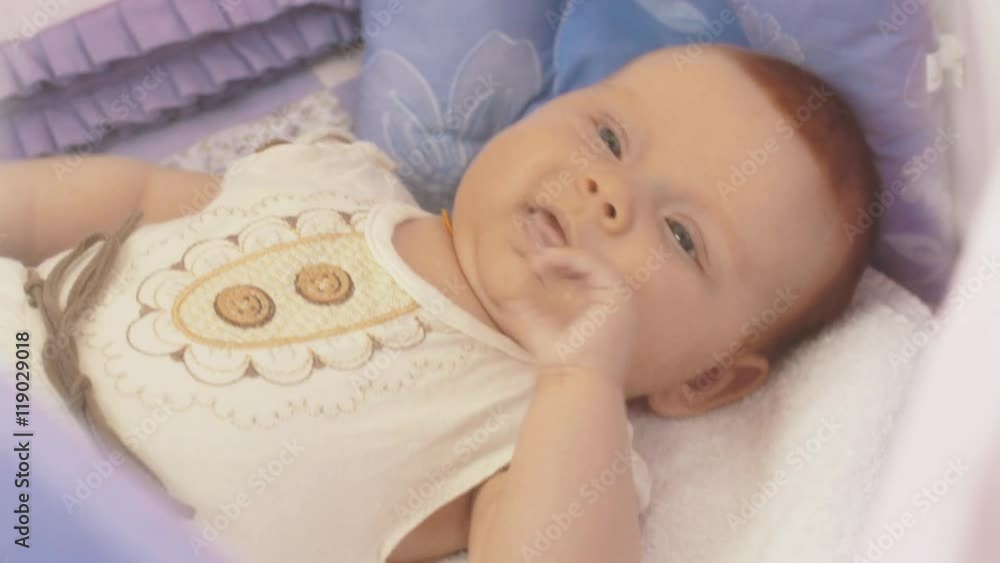 Little baby lie in crib. Motherhood. Mothering. Cute child Happiness ...