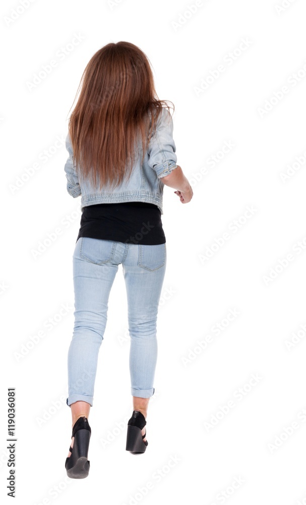 back view of running woman. beautiful red head girl in motion. backside ...