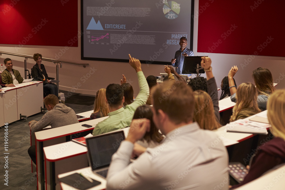 Students at university lecture raise hands to ask questions Stock Photo ...
