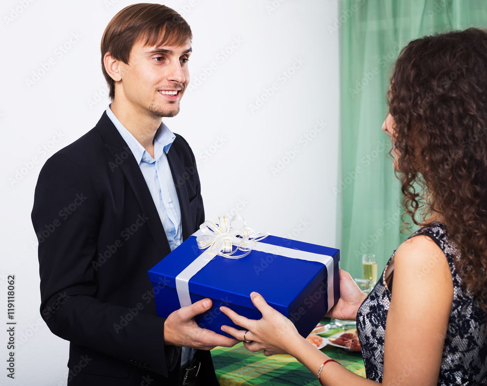 Woman giving present to man Stock Photo | Adobe Stock