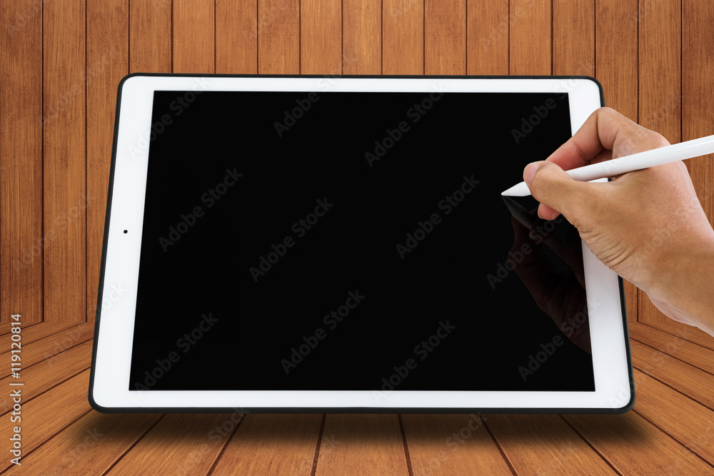 Close-up hand holding digital pen on digital tablet screen, with copy ...