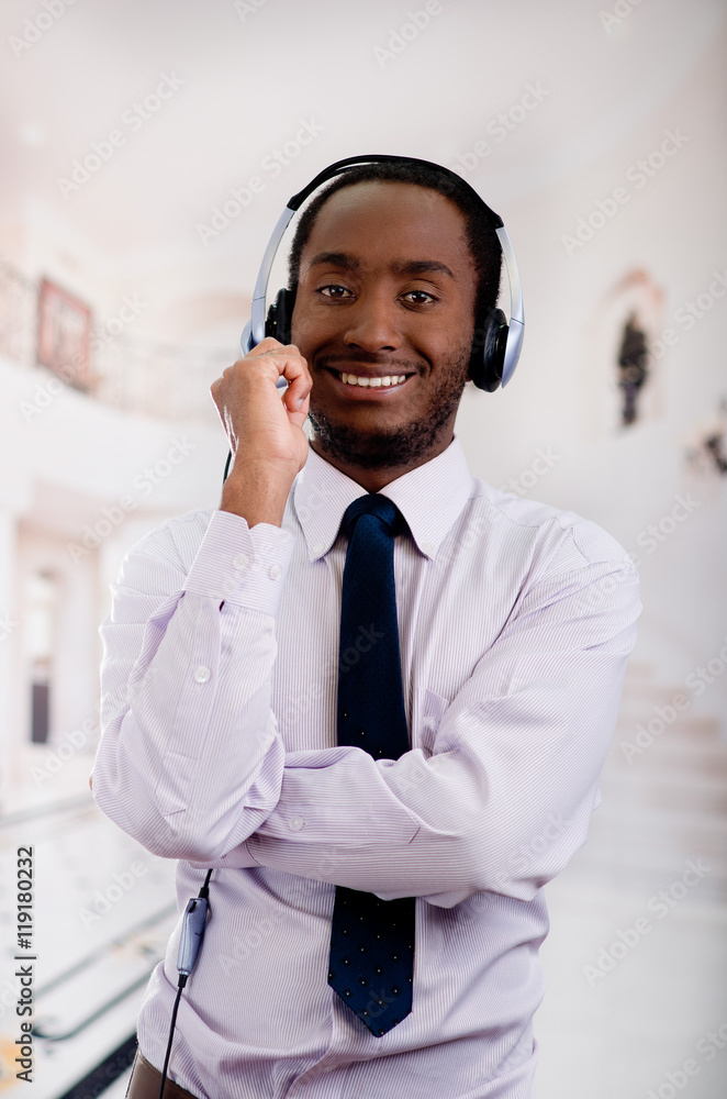 Handsome man wearing headphones with microphone, white striped shirt ...