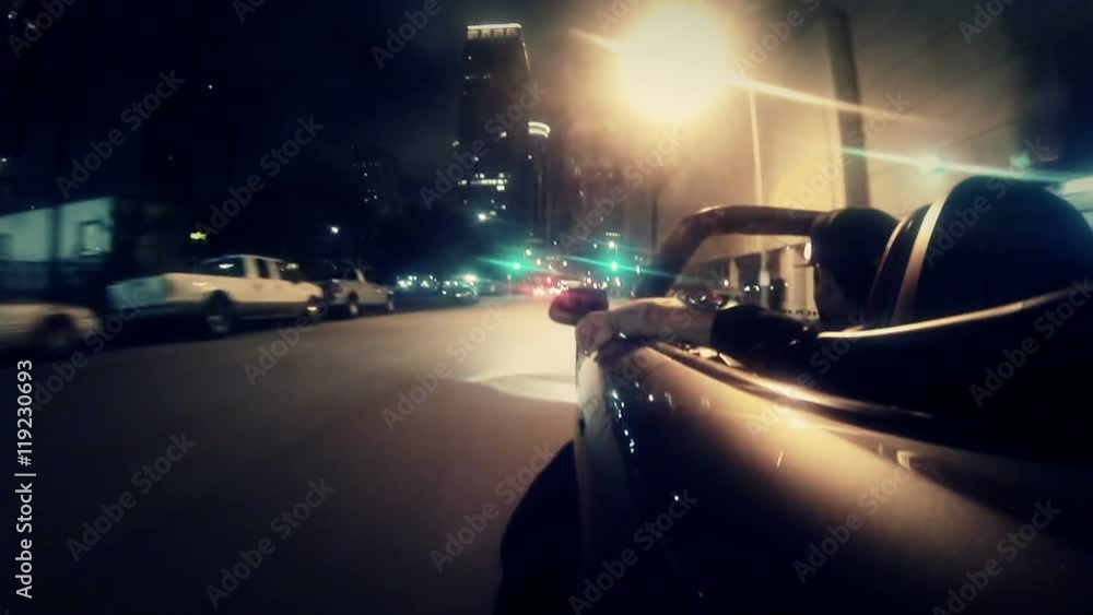 View from outside of vehicle of a sports car driving in the city at ...