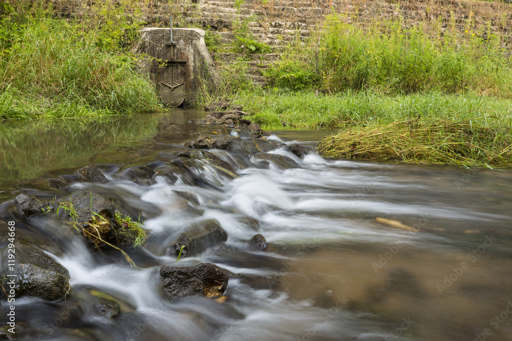 River Rock Dam with Culvert Dam Stock Photo | Adobe Stock