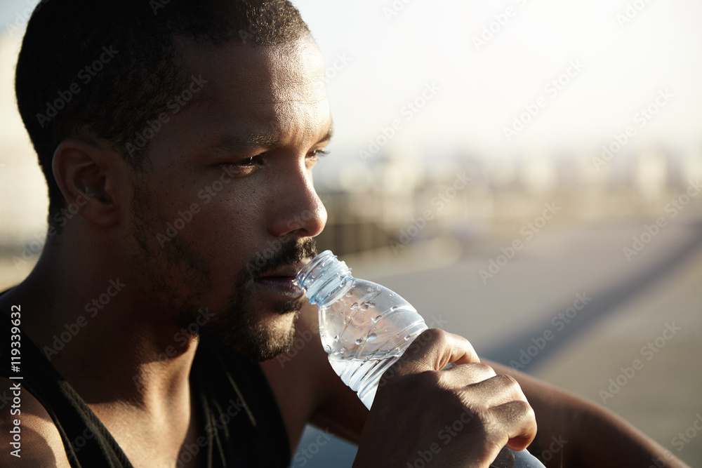 Healthy lifestyle concept. Profile portrait of black man with athletic ...