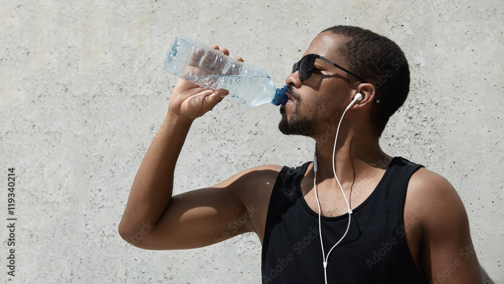 Handsome athlete with strong muscular arms wearing black trainin Stock ...