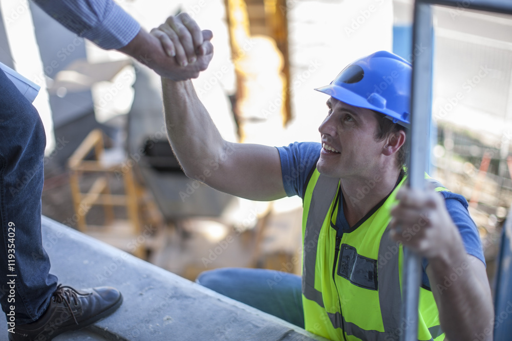 Construction worker shaking hands on construction site Stock Photo ...
