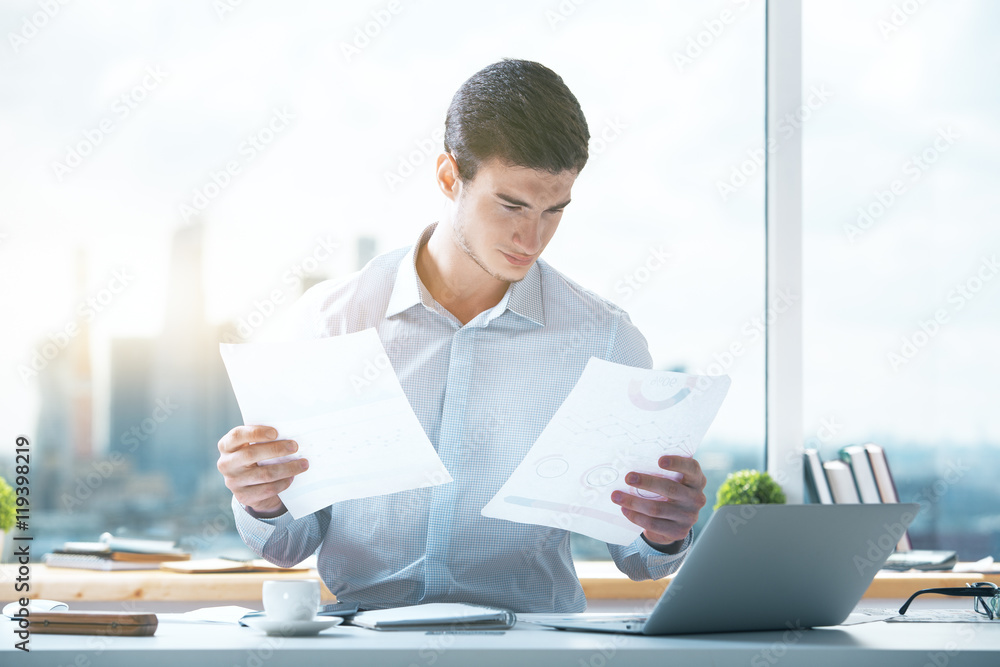 Young man doing paperwork Stock Photo | Adobe Stock