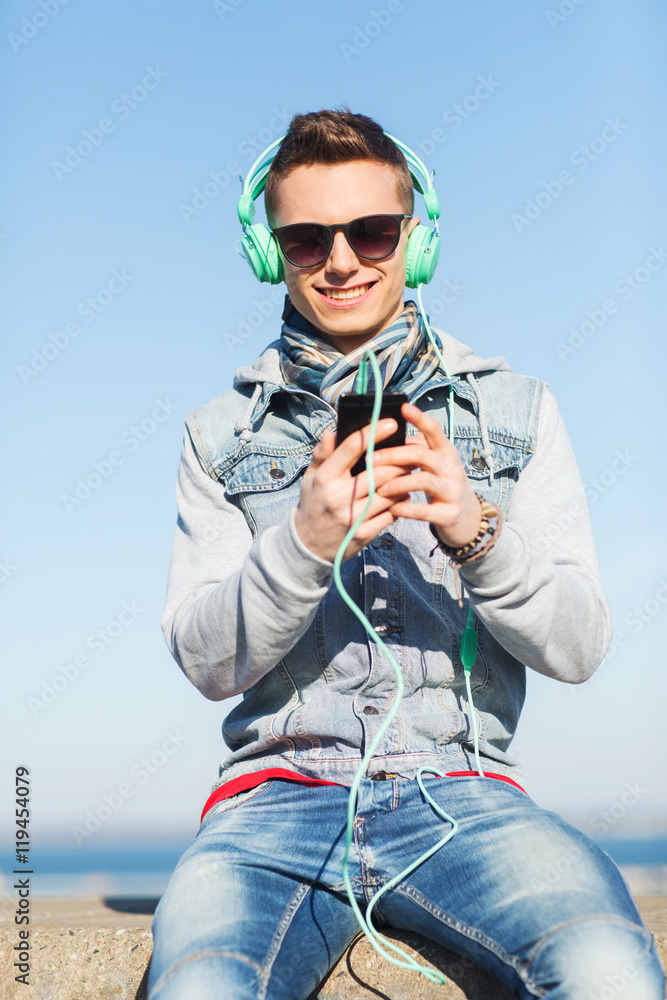 happy young man in headphones with smartphone Stock Photo | Adobe Stock