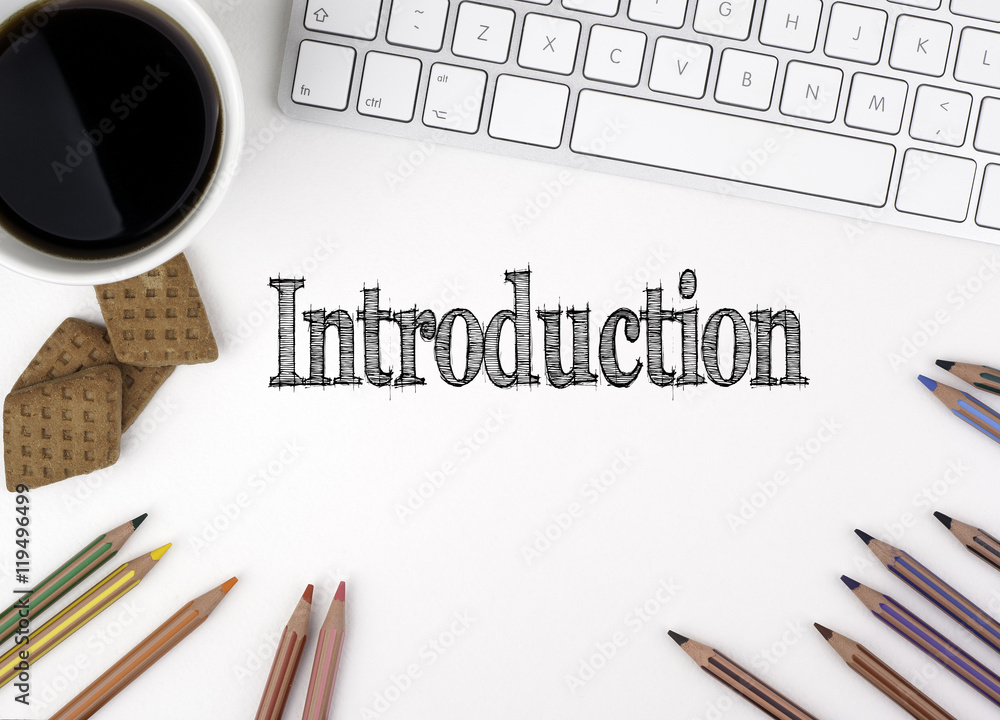 Introduction. On white office desk computer keyboard, pencils, b Stock ...