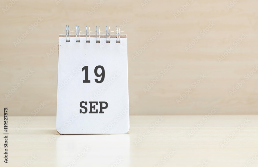 Closeup surface note book with black 19 sep word in page on blurred ...