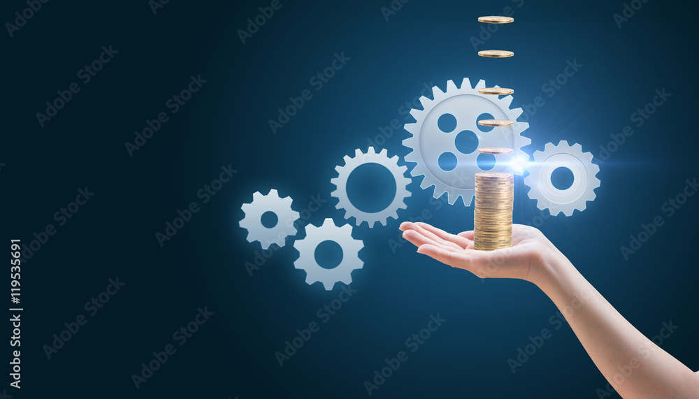 Hand coins and gear mechanism. Stock Photo | Adobe Stock