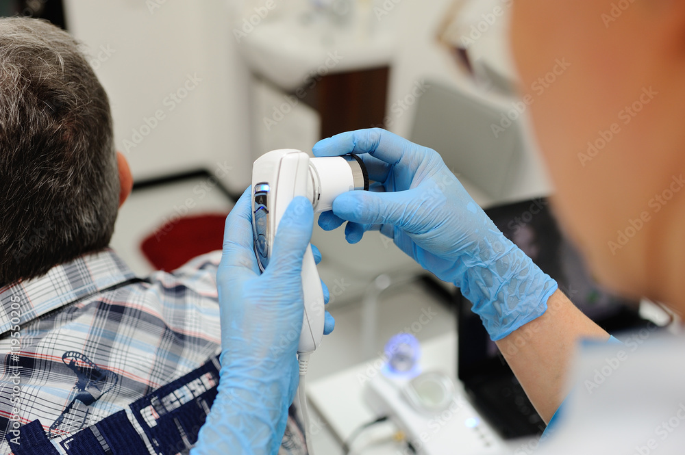 diagnostics hair and scalp. Trihoskopiya. Doctor examine patient male ...