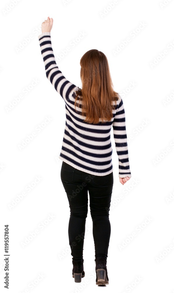 Back view of business woman. Raised his fist up in victory sign. Raised ...