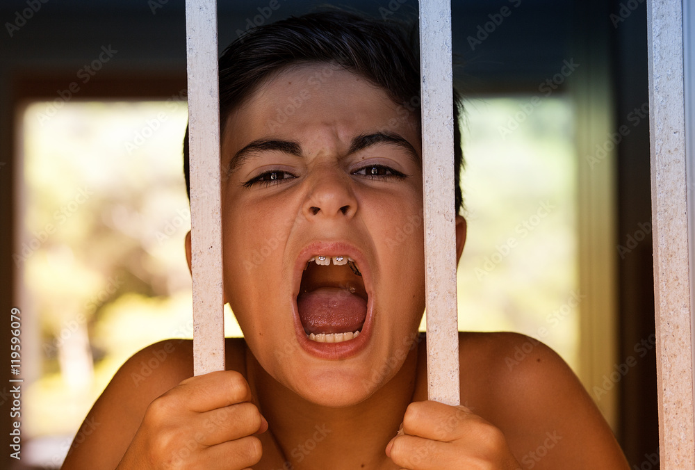 child shouting behind prison bars Stock 写真 | Adobe Stock child shouting behind prison bars Stock 写真 | Adobe Stock
