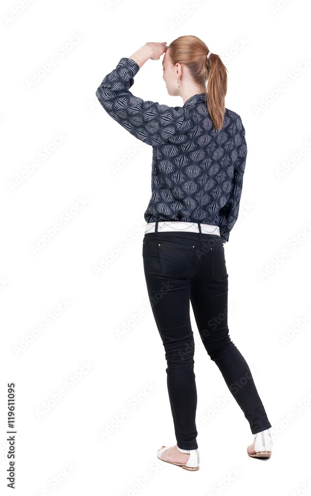back view of standing young beautiful blonde woman in jeans. girl ...