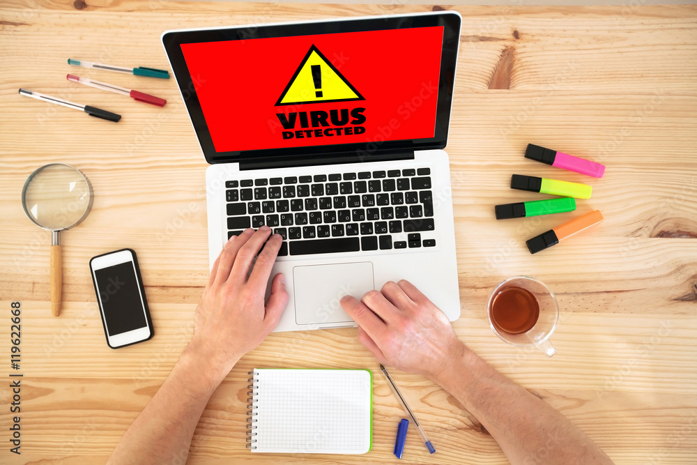 virus alert sign on the screen of computer, top view of workplace ...