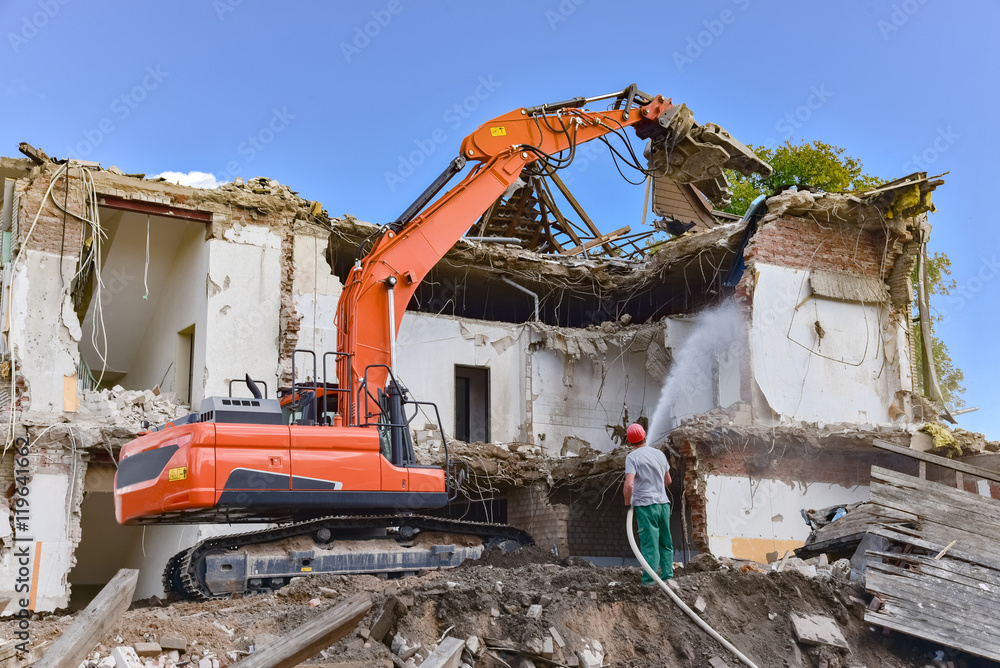 Demolishing a house , excavators and construction workers Stock Photo ...