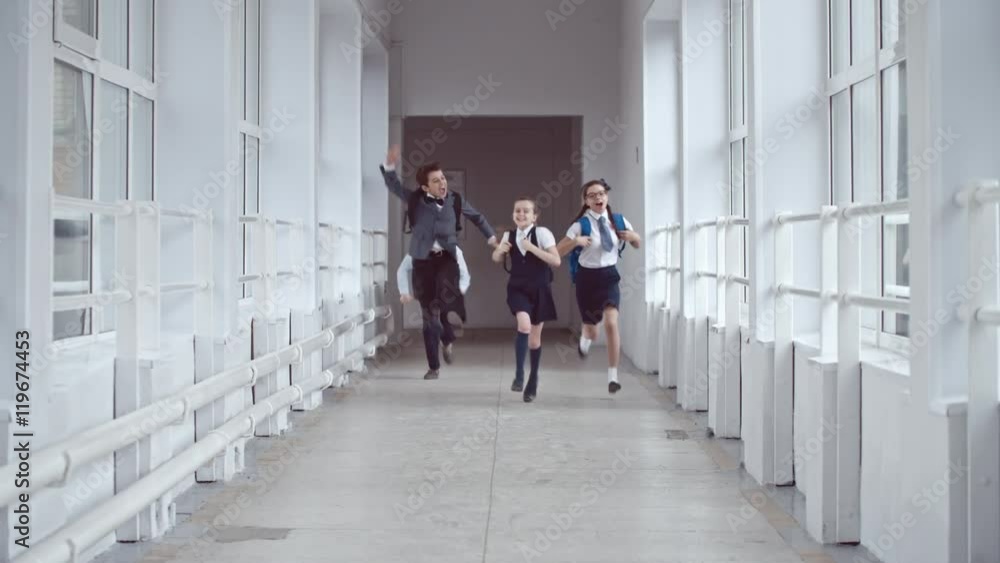 Lockdown of four excited laughing schoolgirls and schoolboys wearing ...