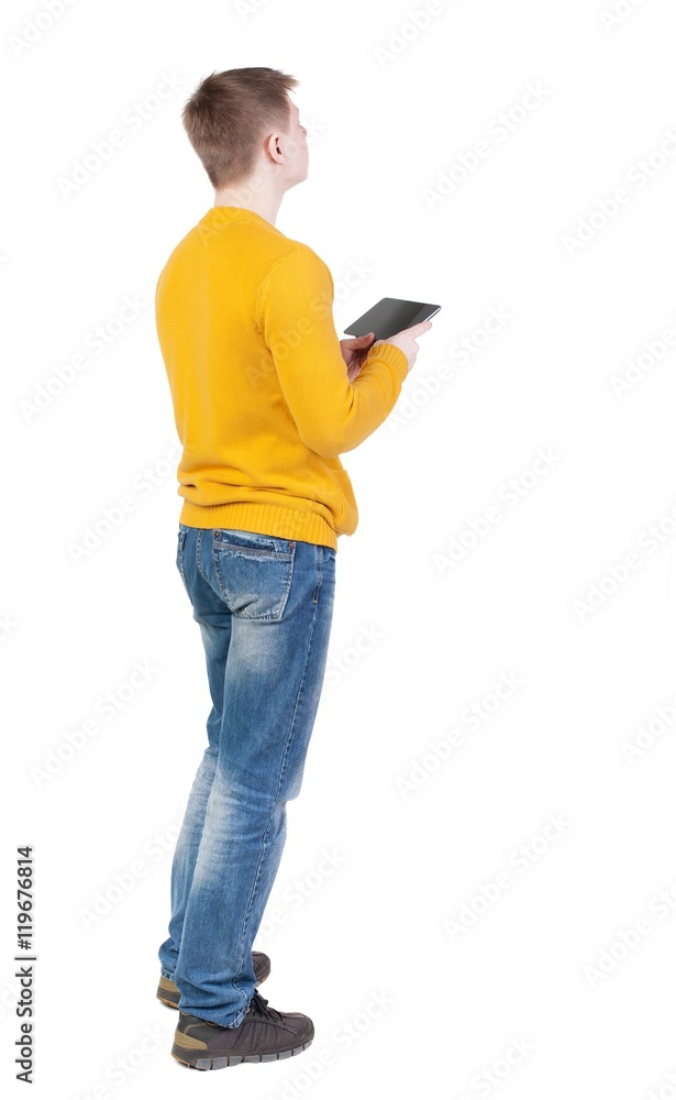 Back view of man with tablet. Standing young guy. Rear view people ...