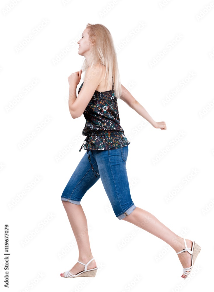 back view of running woman. beautiful blonde girl in motion. backside ...