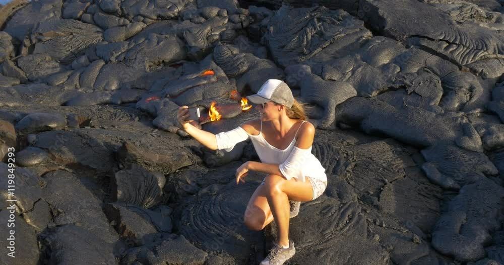 Girl taking picture flowing lava in Kilauea volcano Hawaii. Tourist ...