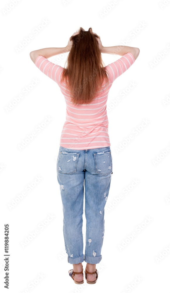 Back view of shocked woman. The girl put her head in her hands in ...