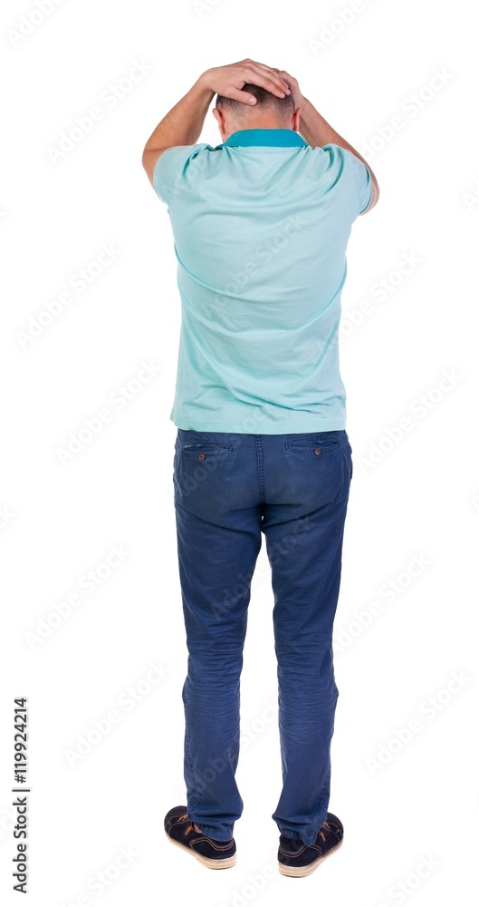 Back view of angry young man in jeans and shirt. Rear view. isolated ...