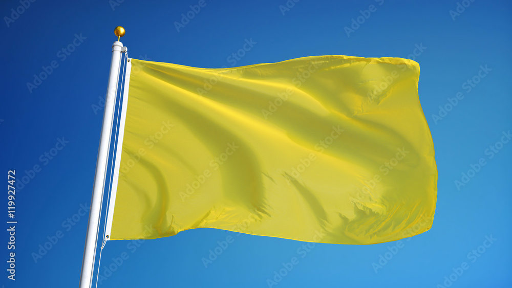 Bright yellow flag waving against clean blue sky, close up, isolated ...