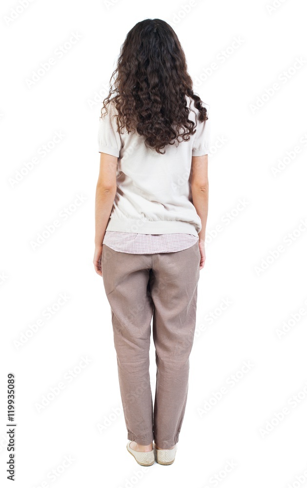 back view of standing young beautiful woman. girl watching. Rear view ...