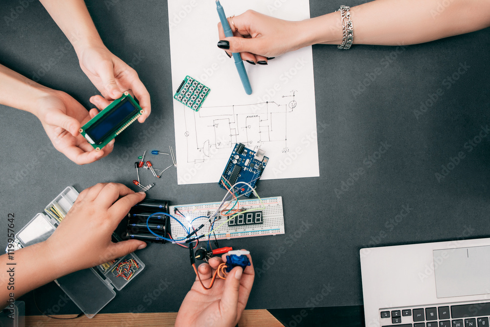 Teamwork engineering of electronic construction. Top view on workplace ...