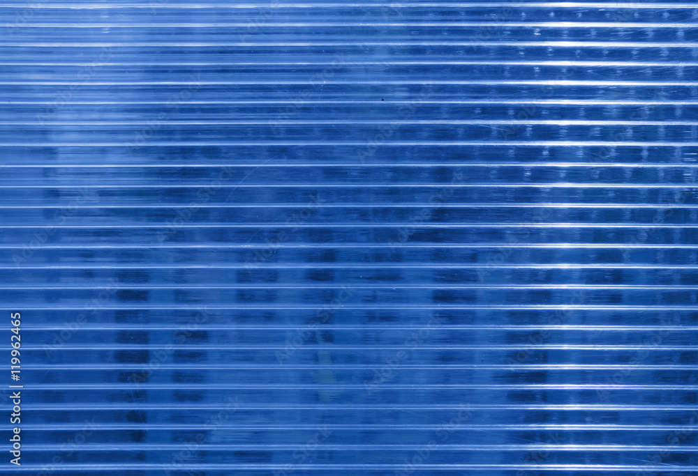 Blue polycarbonate surface with objects behind. Hi-tech background ...