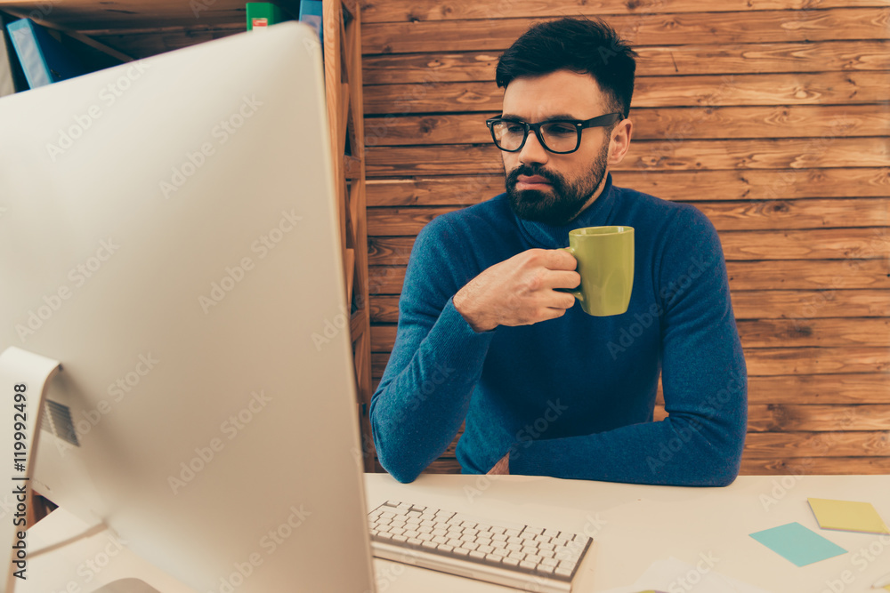 Portrait of smart businessman drinking coffee while working on c Stock ...