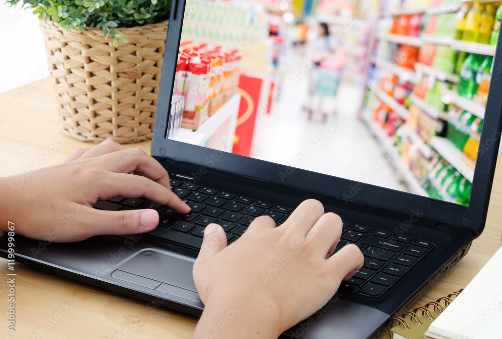 Hand typing labtop with blur supermarket on screen Stock Photo | Adobe ...