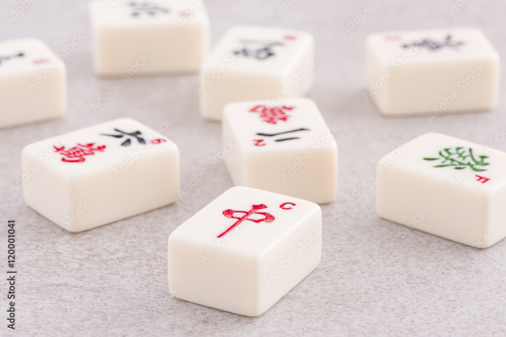 Mahjong board game pieces lying on stone table. Concept of asian or ...